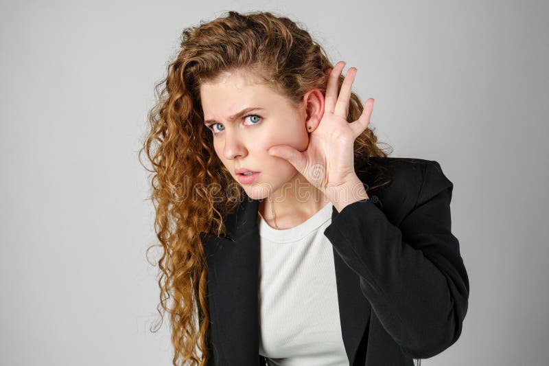 Young Woman Listening with Hand To Ear Stock Photo - Image of focused ...
