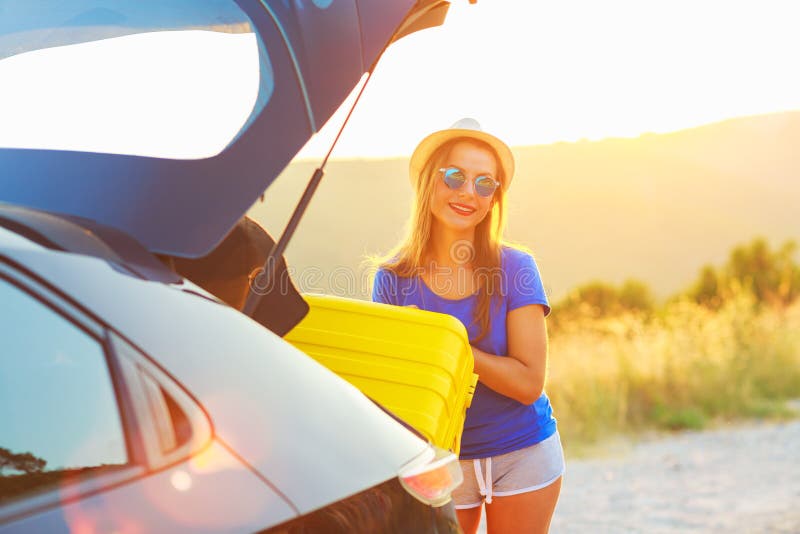 Woman Loading Luggage into the Back of Car Parked Alongside the Stock ...