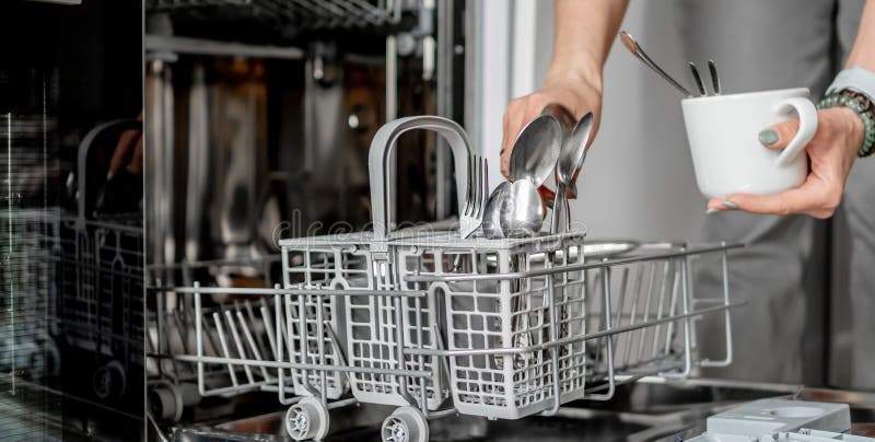 Young Woman Loads Spoons into Dishwasher Stock Photo - Image of kitchen ...