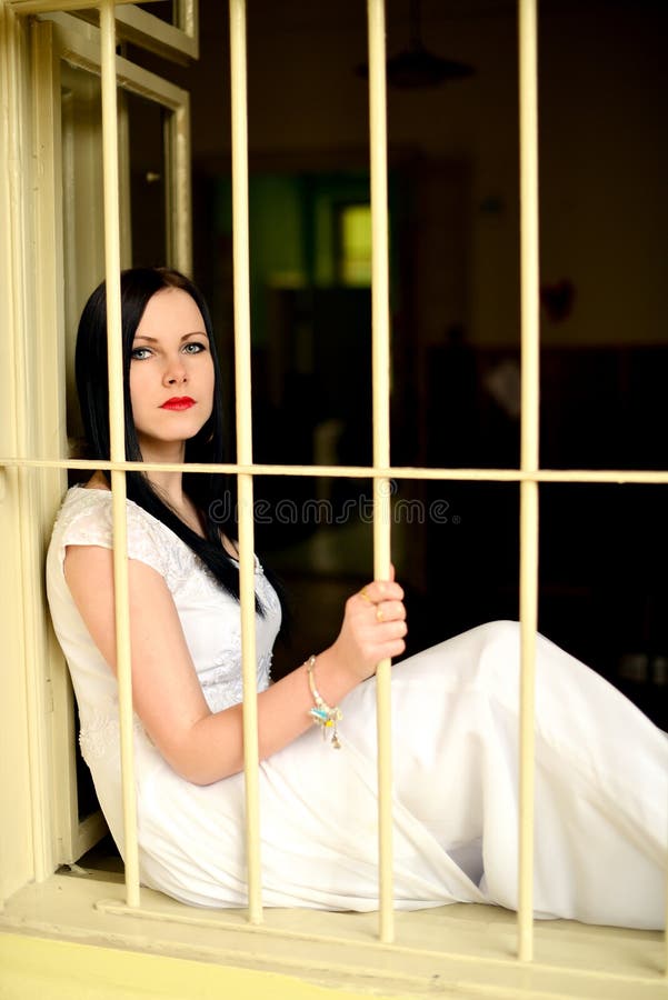 Young Woman Looking from Behind the Bars Stock Image - Image of border ...
