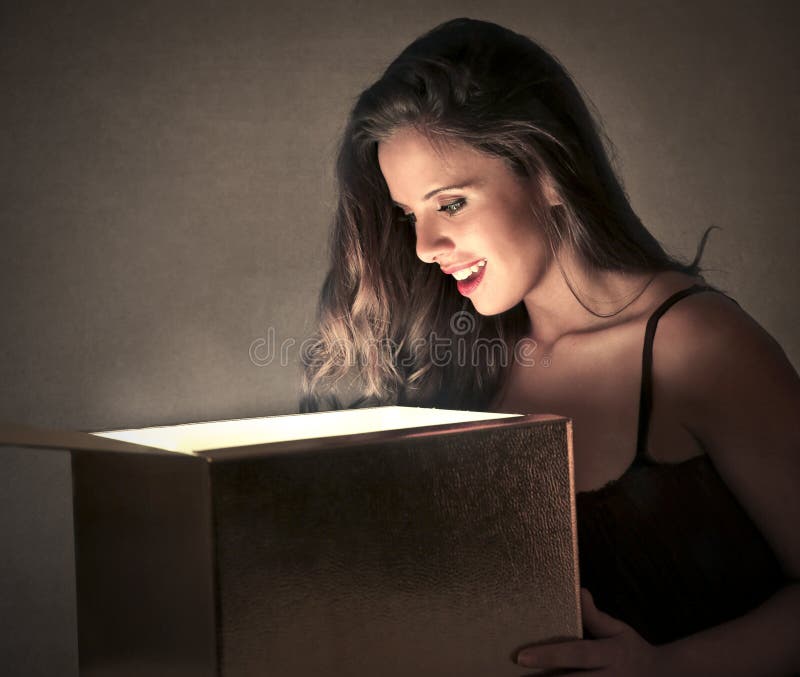 Young Woman Looking into a Box Stock Photo - Image of birthday, wonder ...