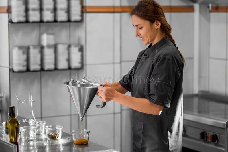 Young Woman Looking Busy while Cooking in the Kitchen Stock Photo ...