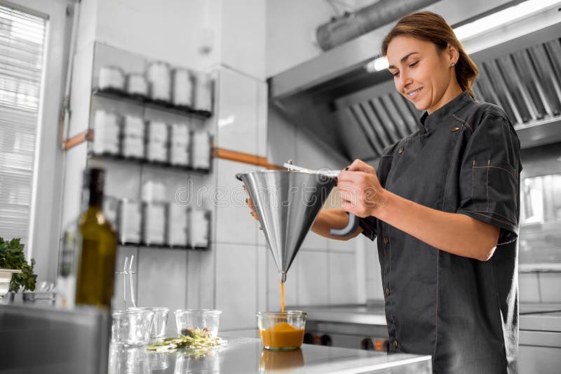 Young Woman Looking Busy while Cooking in the Kitchen Stock Photo ...