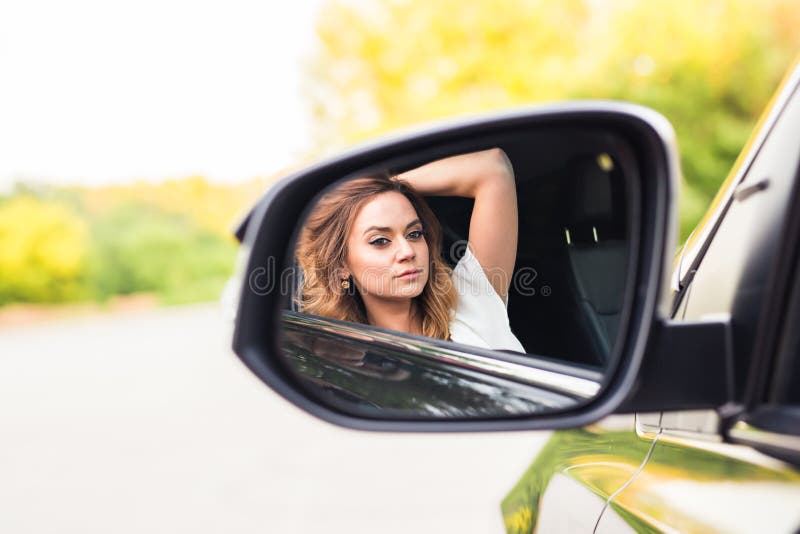 Young Woman Looking in the Car Mirror Stock Photo - Image of beautiful ...