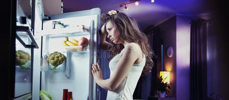 Young Woman Looking at Fridge Stock Photo - Image of people, appliance ...