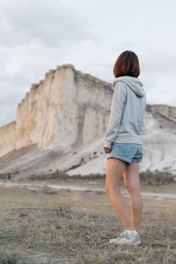 Young Woman Looking into a High Mountain Cliff White . Stock Photo ...