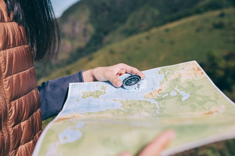 Young Woman Looking on Map and Compass To Checking Her Position Stock ...