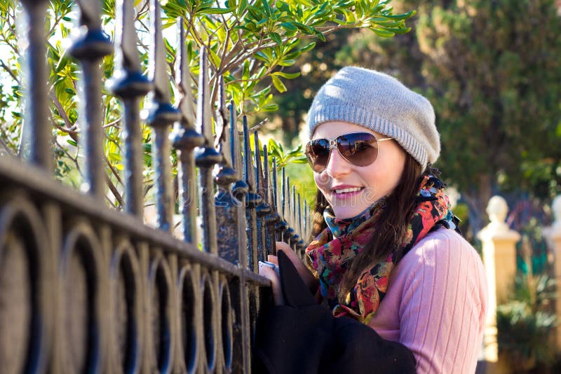 Young Woman Looking Over a Fence and Smiling Stock Image - Image of ...