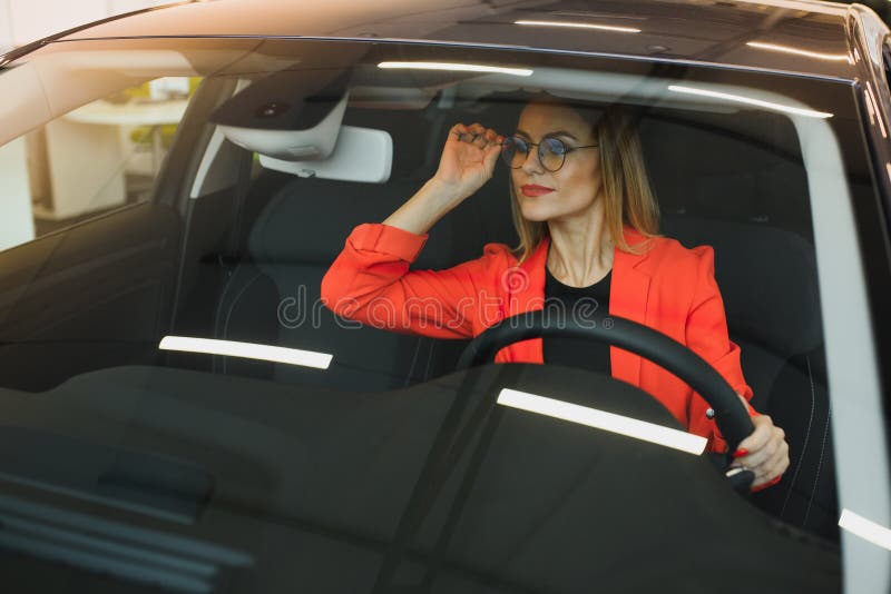 Young Woman Looking in the Rearview Mirror of a Car Stock Photo - Image ...