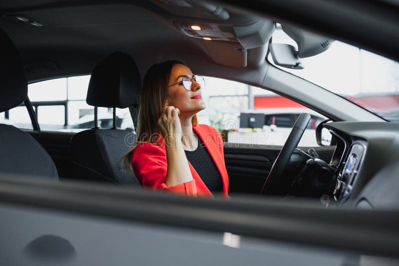 Young Woman Looking in the Rearview Mirror of a Car Stock Photo - Image ...