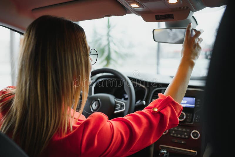 Young Woman Looking in the Rearview Mirror of a Car Stock Image - Image ...