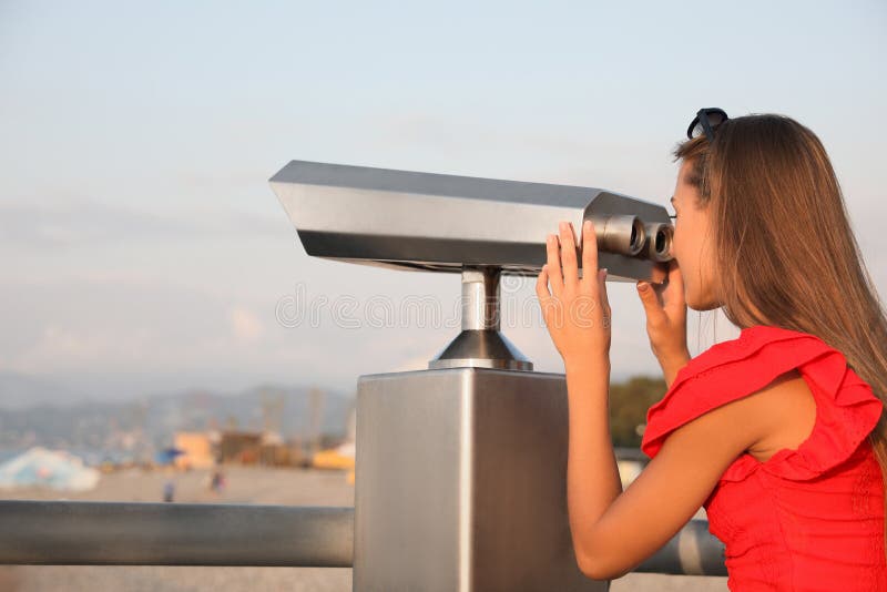 Young Woman Looking through Tourist Viewing Machine at Observation Deck ...