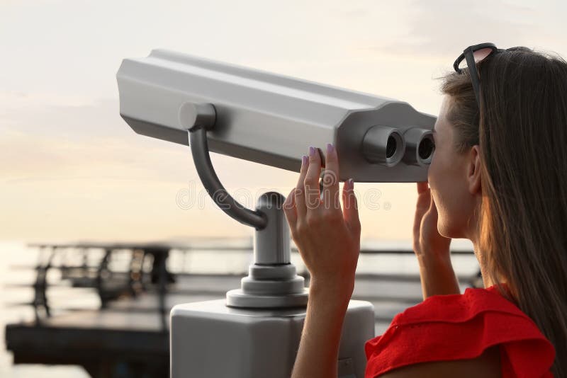 Young Woman Looking through Tourist Viewing Machine at Observation Deck ...