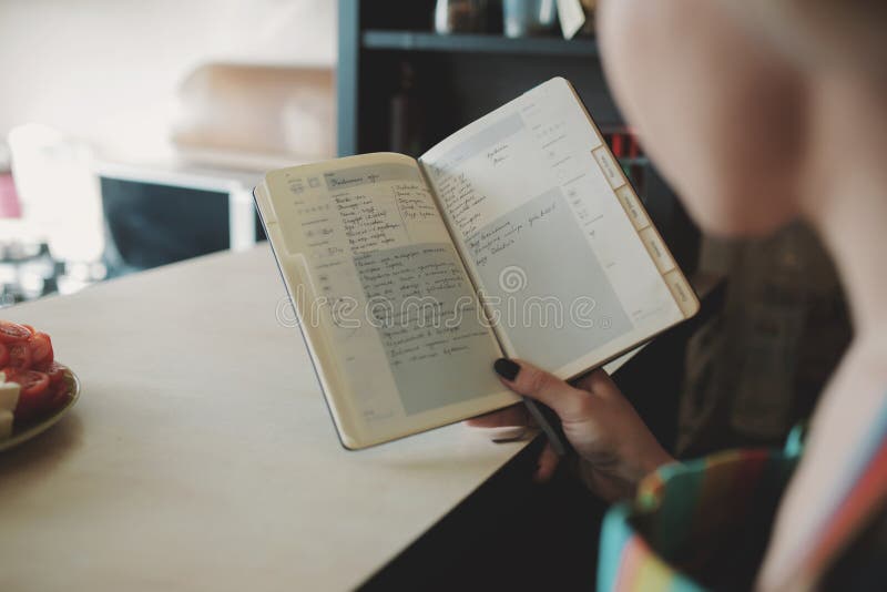 Young Woman Looking Up in a Recipes Book Stock Photo - Image of ...