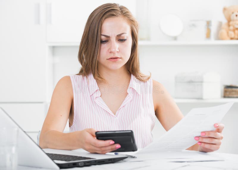 Young Woman Looking Worriedly at Bills Stock Photo - Image of billing ...