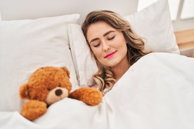 Young Woman Lying on Bed Sleeping with Teddy Bear at Bedroom Stock ...