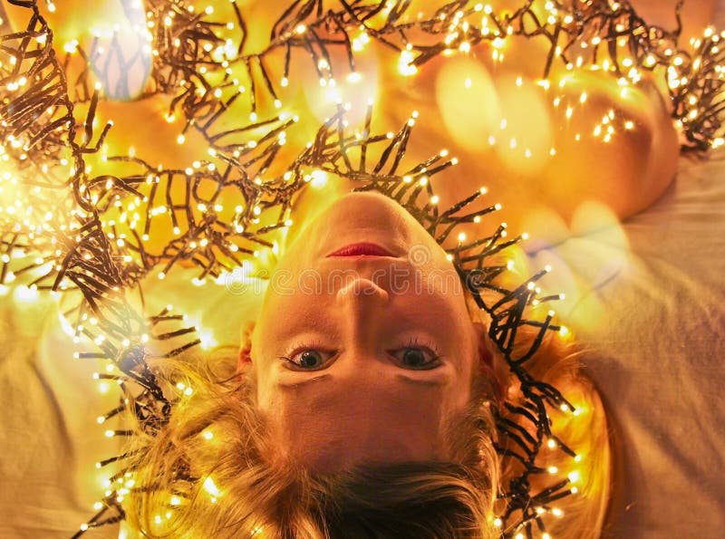 Young Woman Lying on Bed with Small Lights Around Body Stock Image ...