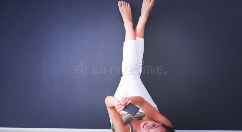Young Woman Lying on the Floor with Legs Up Stock Image - Image of ...