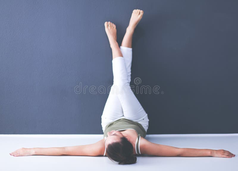 Young Woman Lying on the Floor with Legs Up Stock Photo - Image of ...