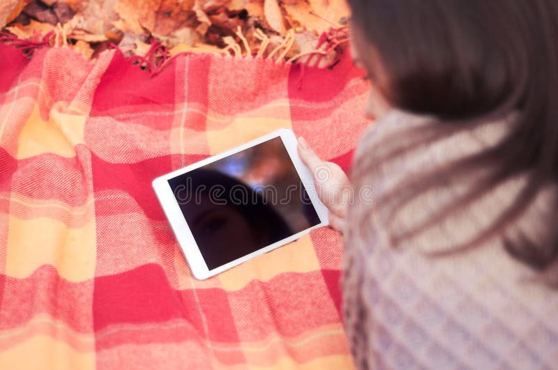 Young Woman Lying on a Rug and Using Tablet Stock Photo - Image of ...