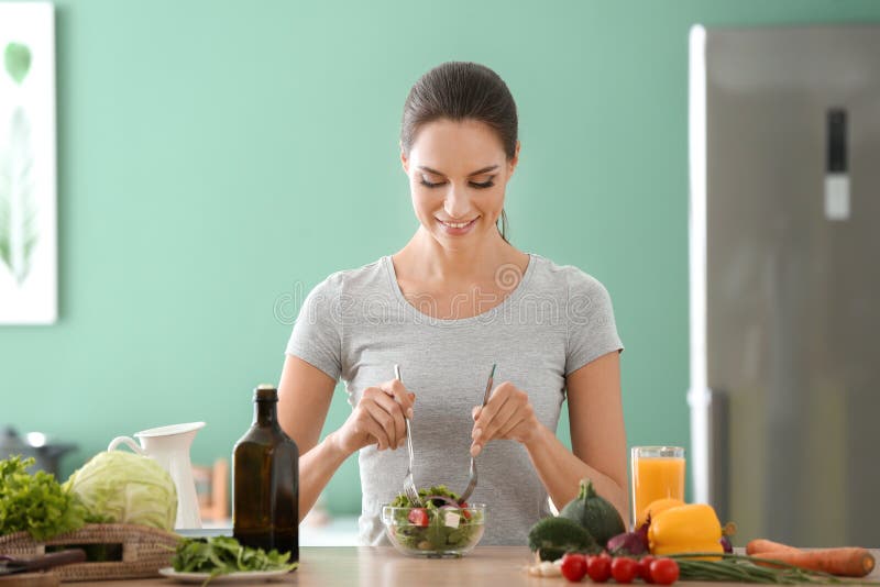 Young Woman Making Fresh Vegetable Salad in Kitchen Stock Photo - Image ...