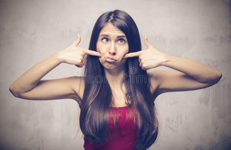 Young Woman Making a Funny Face Stock Image - Image of cheerful, colors ...