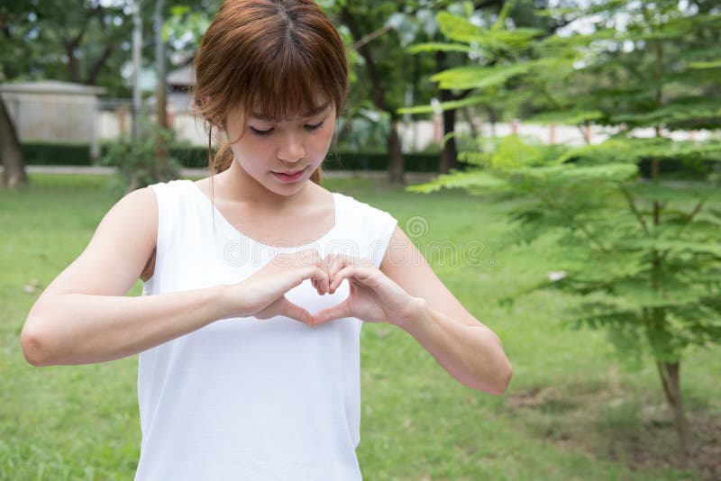 Young Woman Making A Heart Gesture With Her Fingers Asian Girl Stock