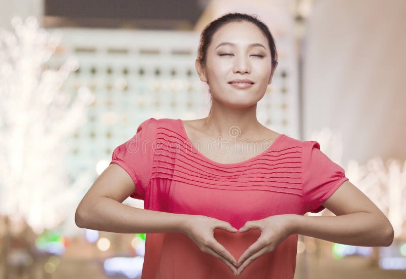 Young Woman Making Heart Sign with Hands Stock Photo - Image of china ...