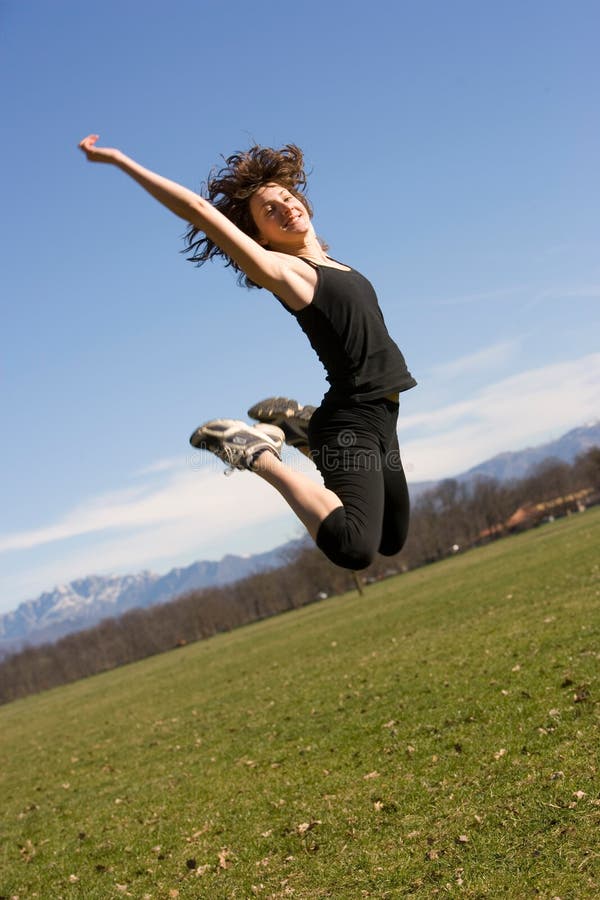 Young woman making a jump stock photo. Image of attractive - 4592382