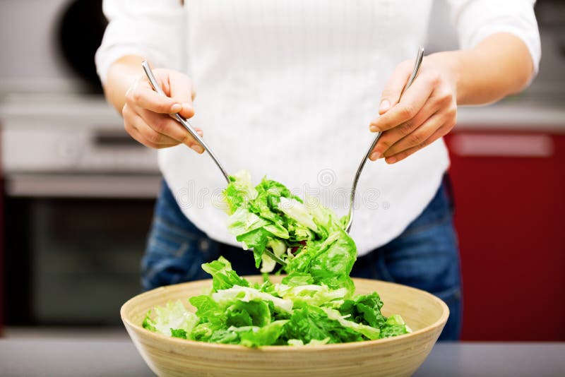 Young woman making salad stock image. Image of closeup - 48960753
