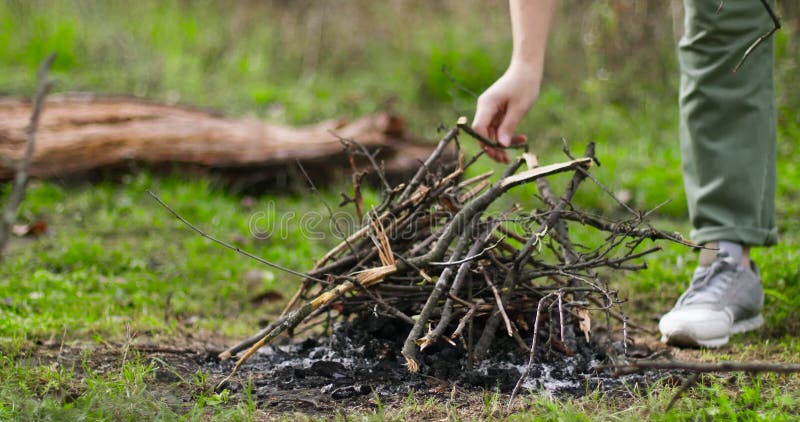 Young Woman with a Match Lights a Branches for the Campfire in the ...