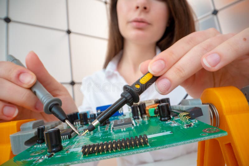 Young Woman with Measuring Devices in the Electronics Engineer ...