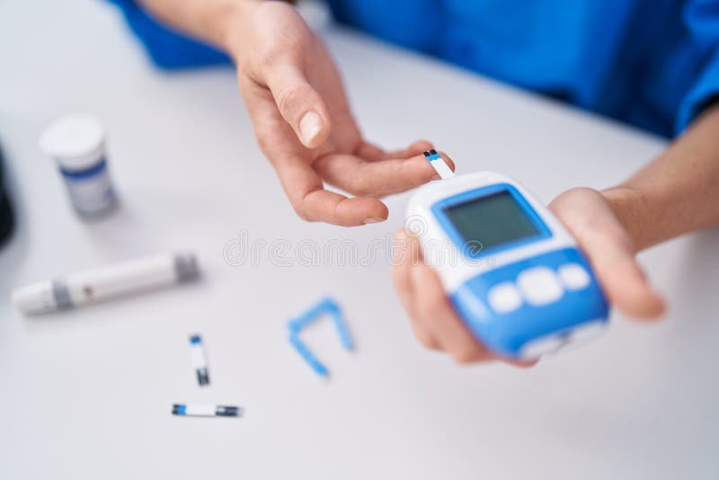 Young Woman Measuring Glucose Using Glucometer at Home Stock Image ...