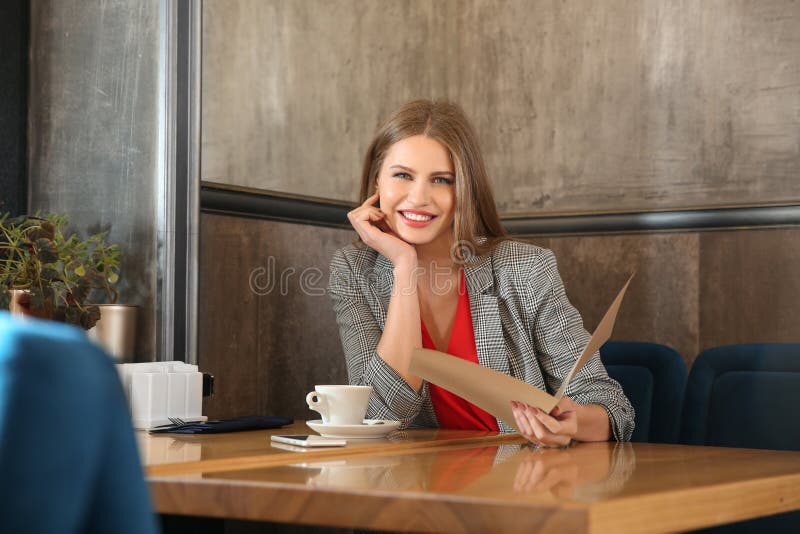 Young Woman with Menu Sitting in Restaurant Stock Photo - Image of ...
