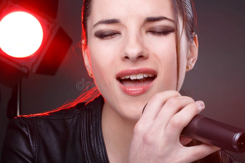Young Woman with Microphone Stock Photo - Image of musician, song: 39242584