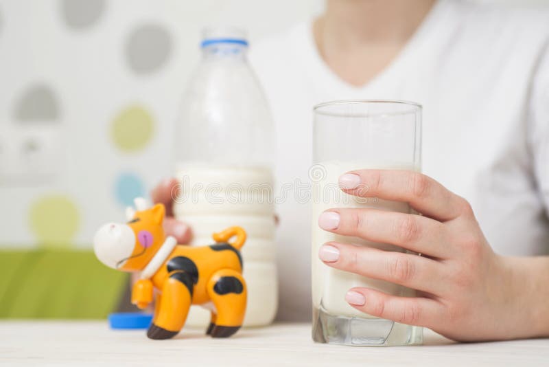 Young Woman with Milk in the Kitchen at Home. Female Drinks Milk in the ...