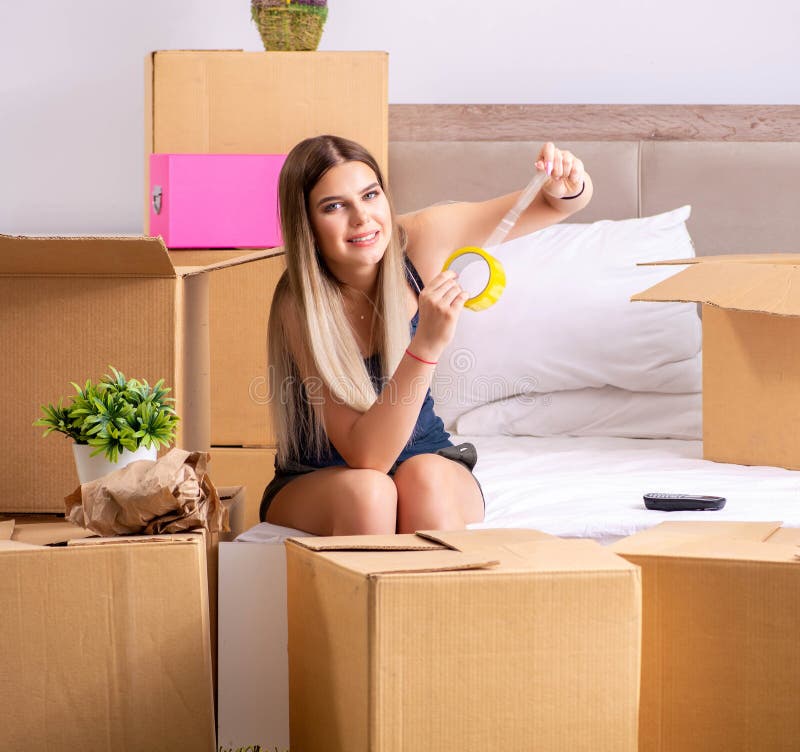 Young Woman Moving To New Place Stock Photo - Image of flat, cargo ...