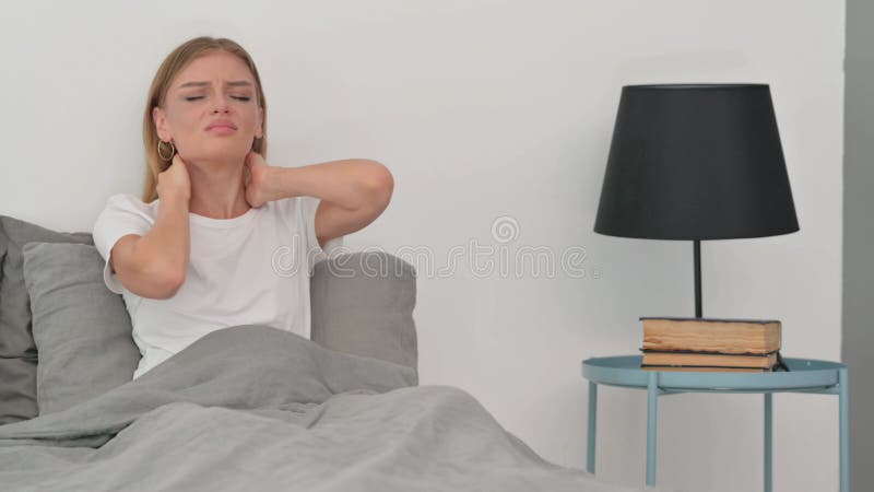 Young Woman with Neck Pain Sitting in Bed Stock Video - Video of lying ...