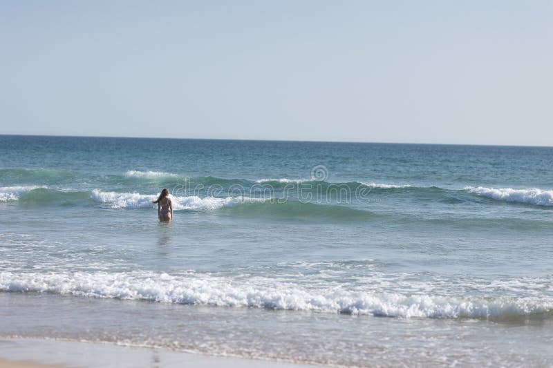 A Young Woman with Nice Body Standing in the Ocean - Back View Stock ...