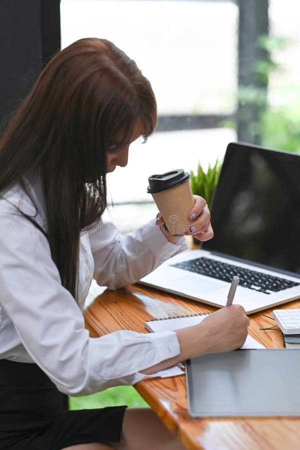 Woman Office Worker Drinking Coffee and Working at Her Office Desk ...