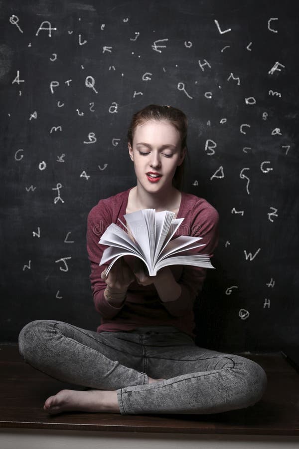 Young woman opening a book stock photo. Image of school - 39521924