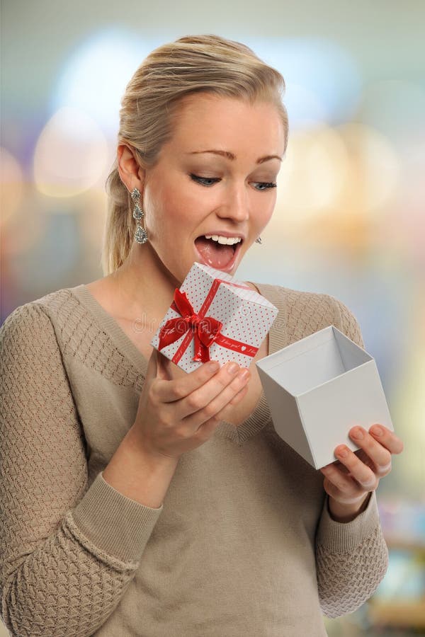 Young Woman Opening Present Stock Photo - Image of holding, gift: 60381162