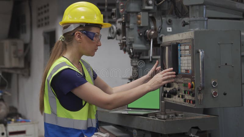 Young Woman Operation of the Old Machine Via the Remote Computer. Young ...