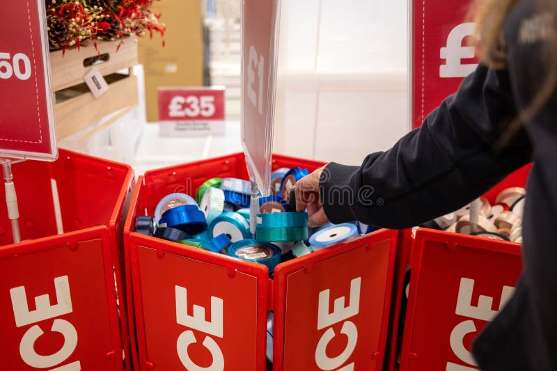 A Woman Putting Things in the Bins at a Store Stock Photo - Image of ...