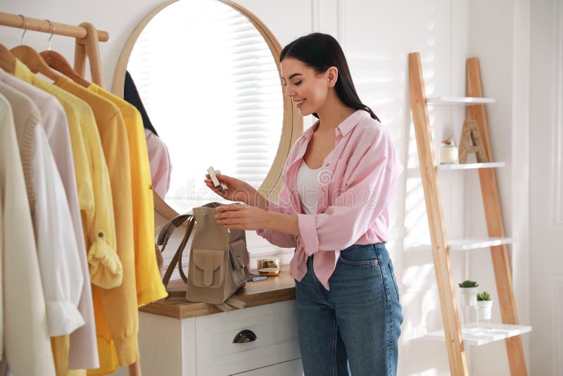 Young Woman Packing Backpack for Work Day at Home. Morning Routine ...