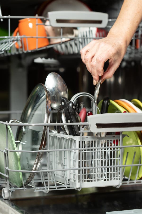 Young Woman Packing the Dishes into the Dishwasher Stock Photo - Image ...