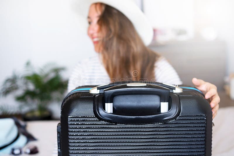 Young Woman Packing a Suitcase at Home Going on Holiday Stock Photo ...
