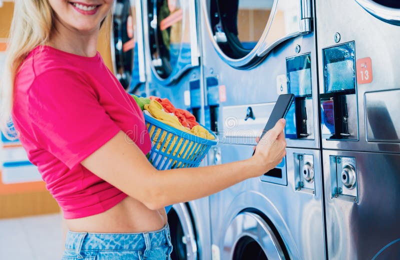 Young Woman Pays for Laundry Service Using Phone and Banking ...