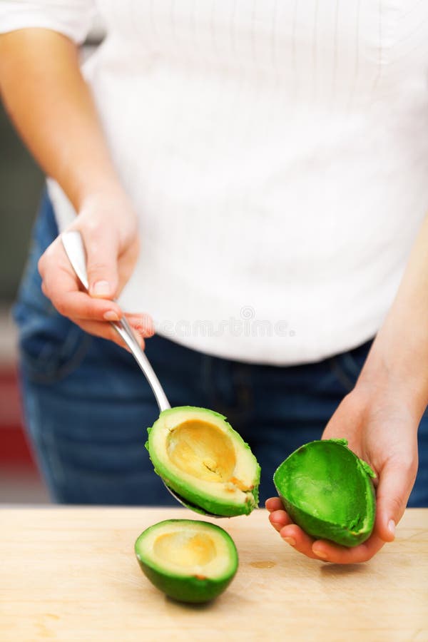 Young Woman Peeling Avocado Stock Photo - Image of portion, avocado ...
