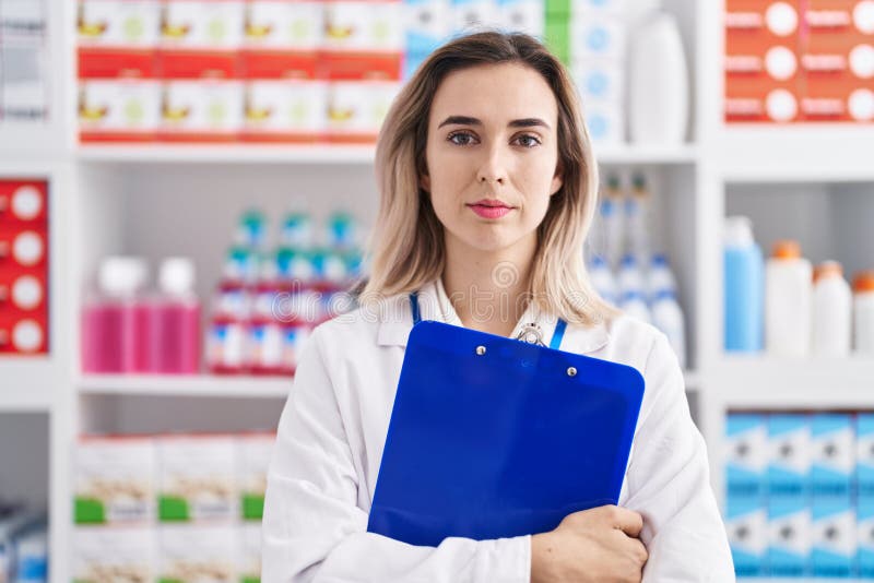 Young Woman Pharmacist Holding Checklist at Pharmacy Stock Image ...